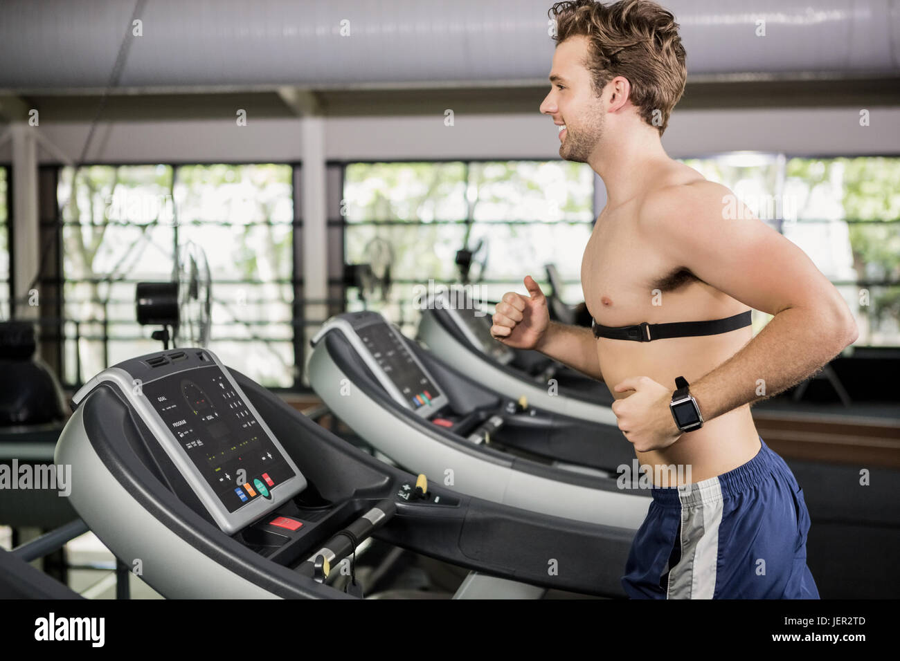 Man running on thread mill Stock Photo - Alamy