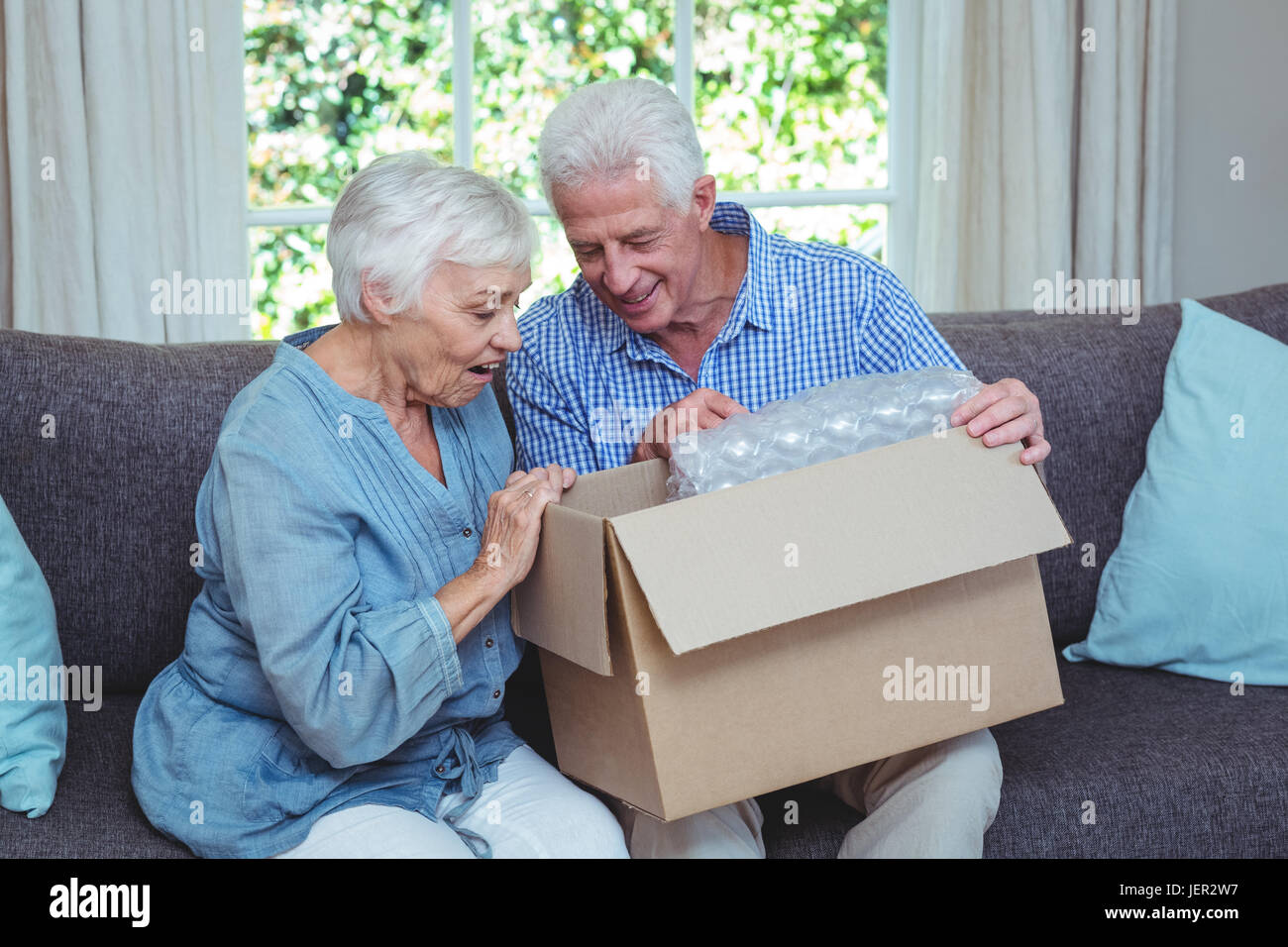 Woman sitting inside cardboard box hi-res stock photography and images ...
