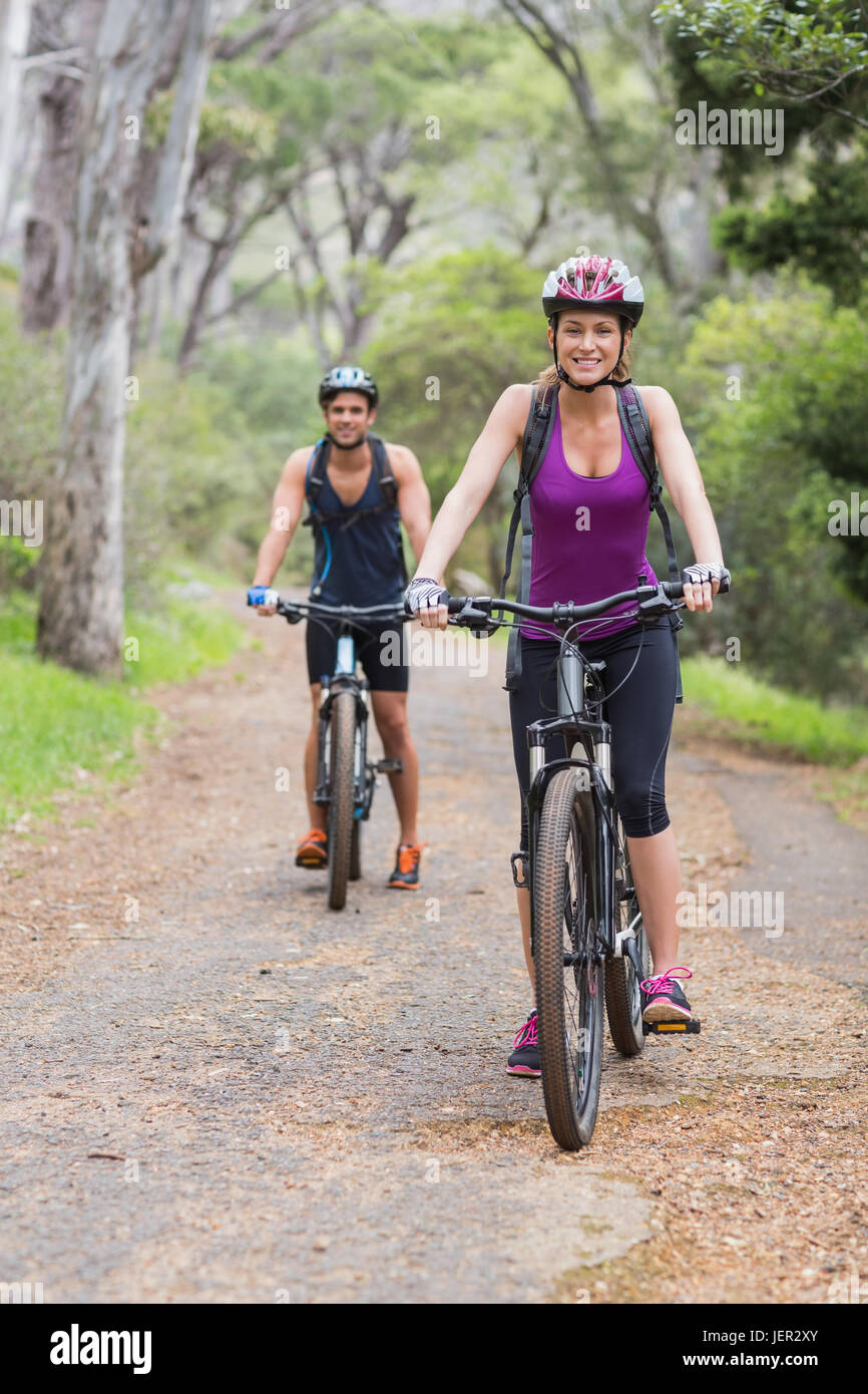Portrait of bikers riding bike in forest Stock Photo - Alamy
