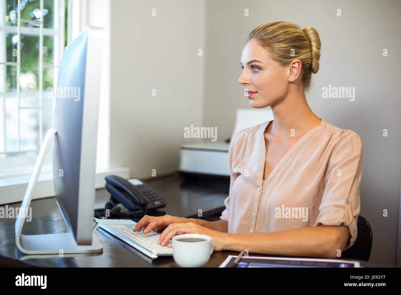 Focused businesswoman working on computer Stock Photo - Alamy