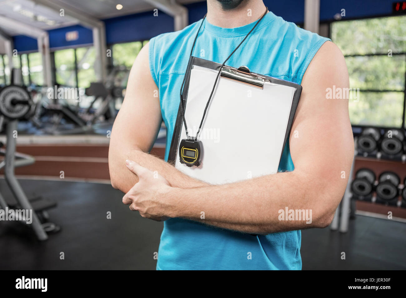 Gym instructor holding clipboard Stock Photo - Alamy