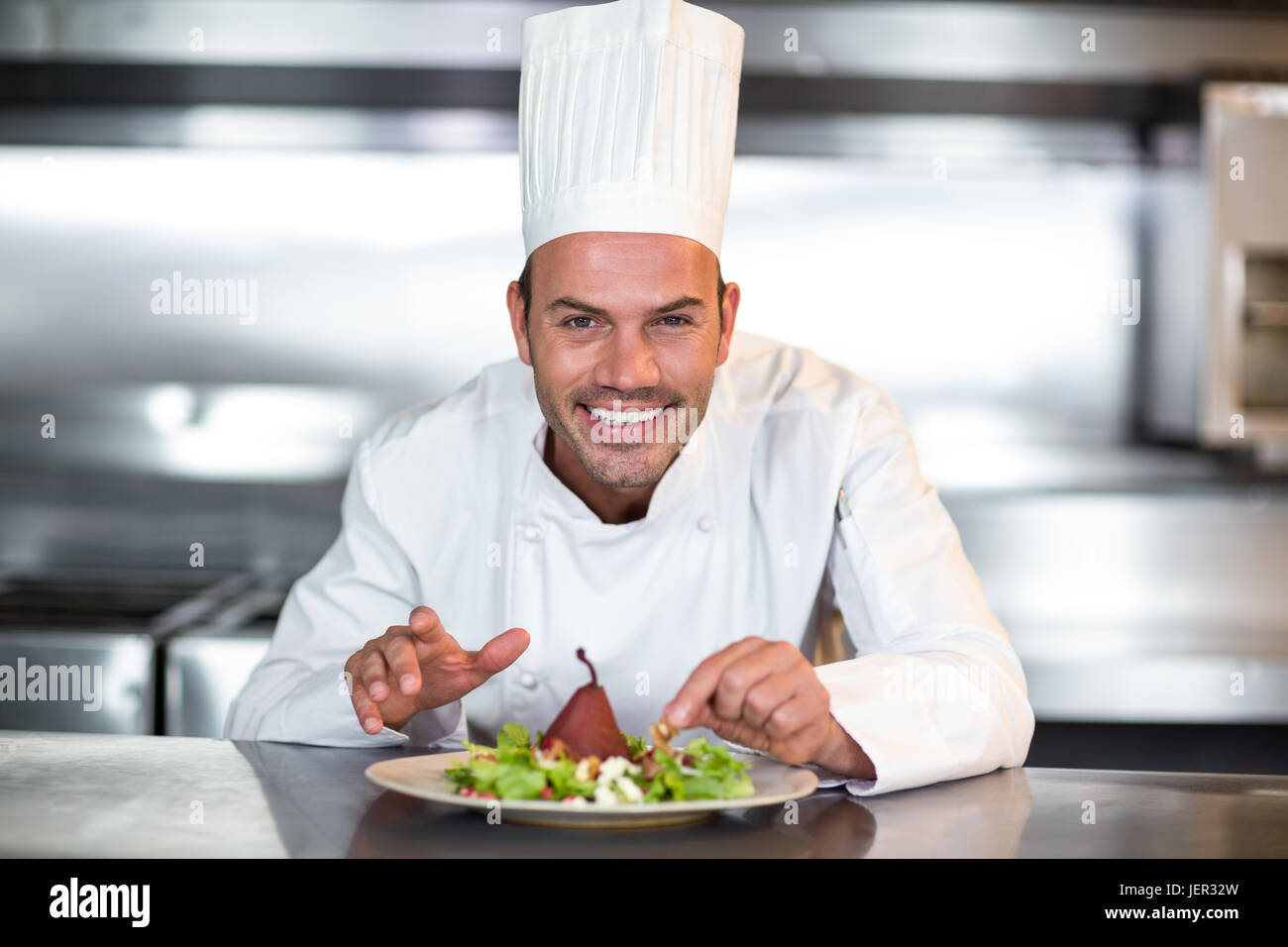 Portrait of happy chef garnishing food Stock Photo - Alamy