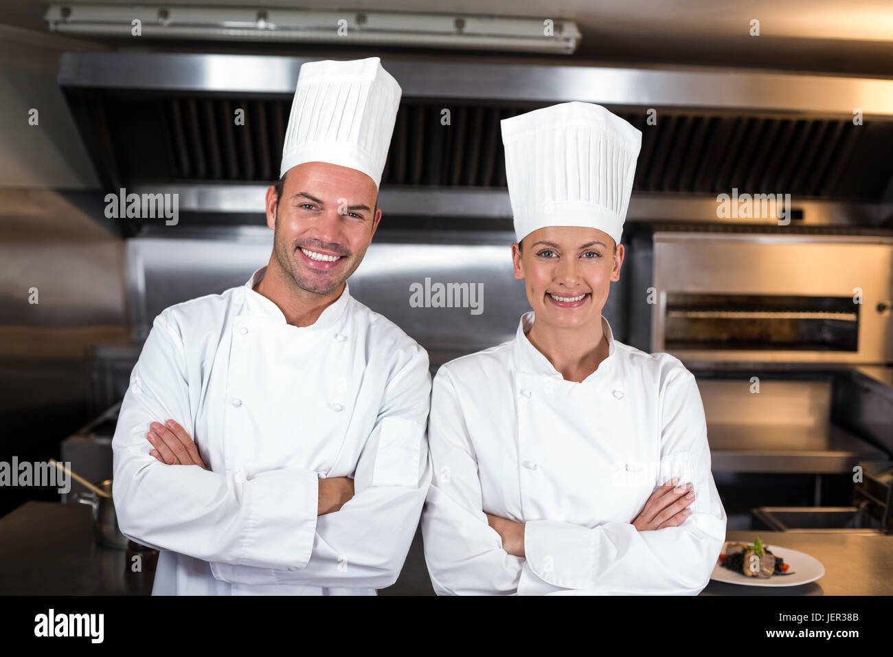 Portrait happy chef standing arm hi-res stock photography and images ...