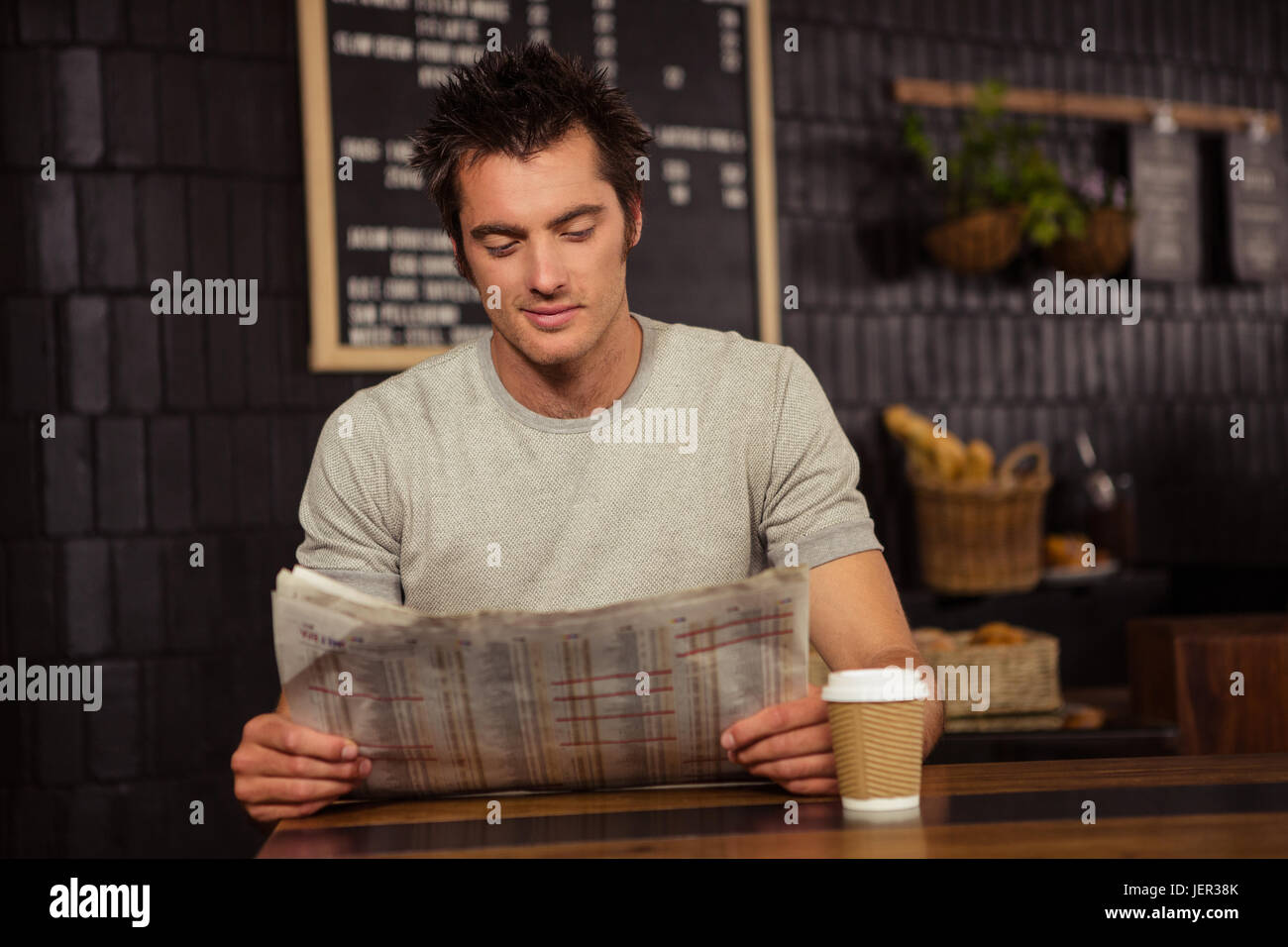 Man reading the newspaper Stock Photo - Alamy