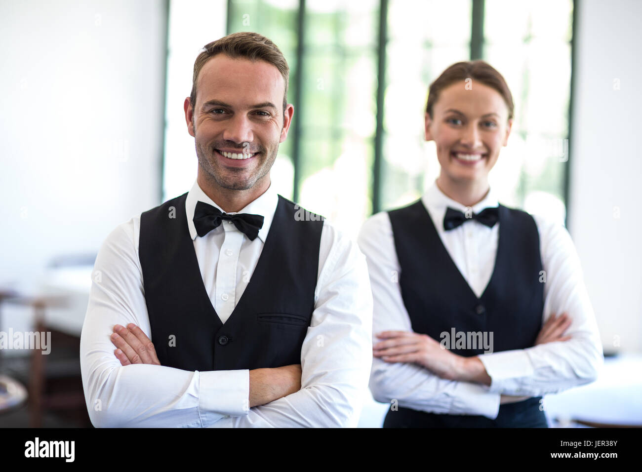 Waiting staff smiling at camera Stock Photo - Alamy