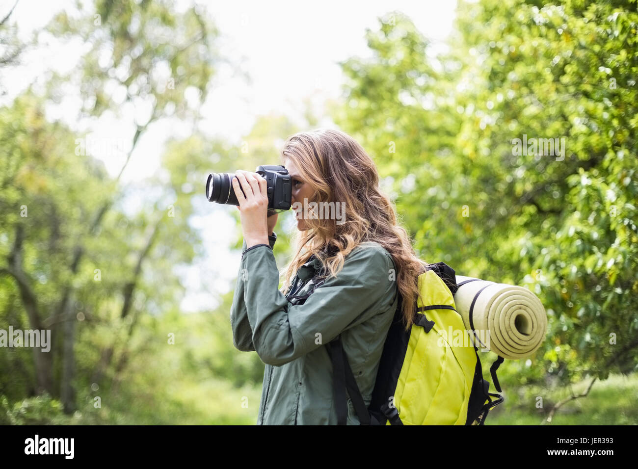 Woman clicking photograph with camera Stock Photo - Alamy