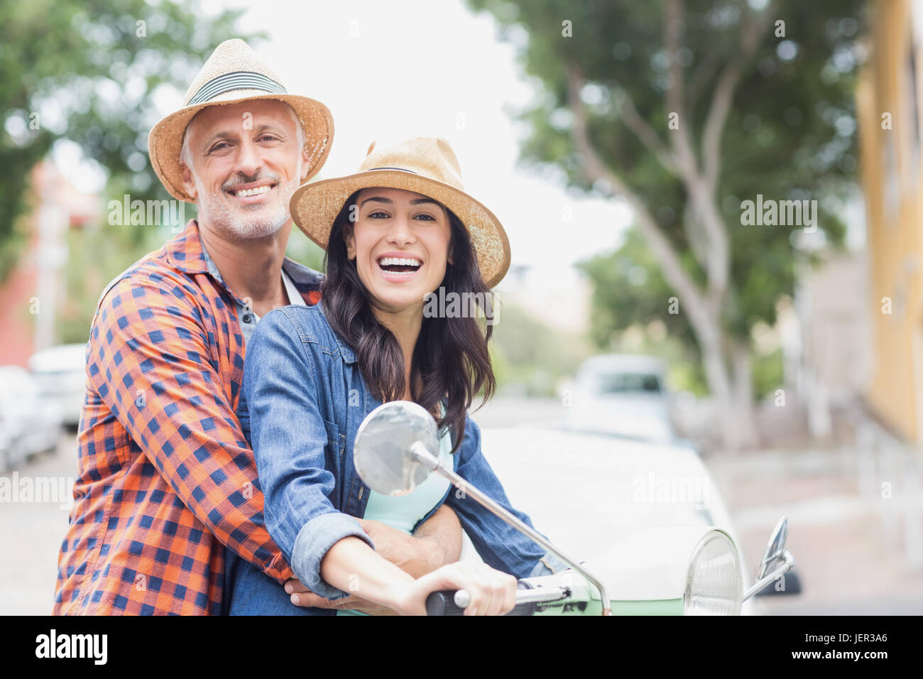 Portrait of couple on moped Stock Photo - Alamy