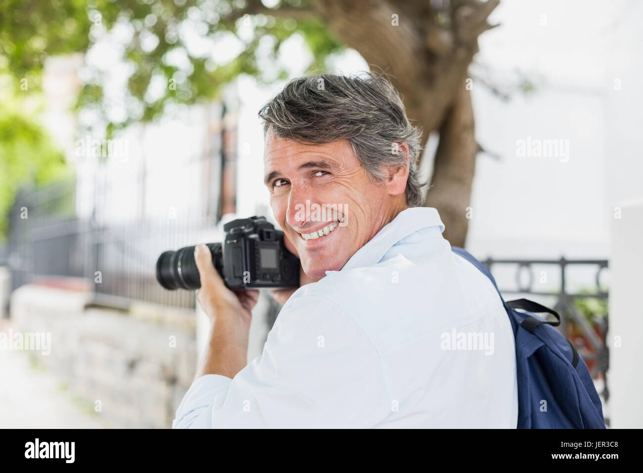 Rear view portrait of man using camera Stock Photo - Alamy