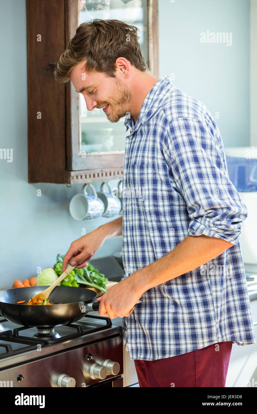 Man preparing food in kitchen Stock Photo - Alamy