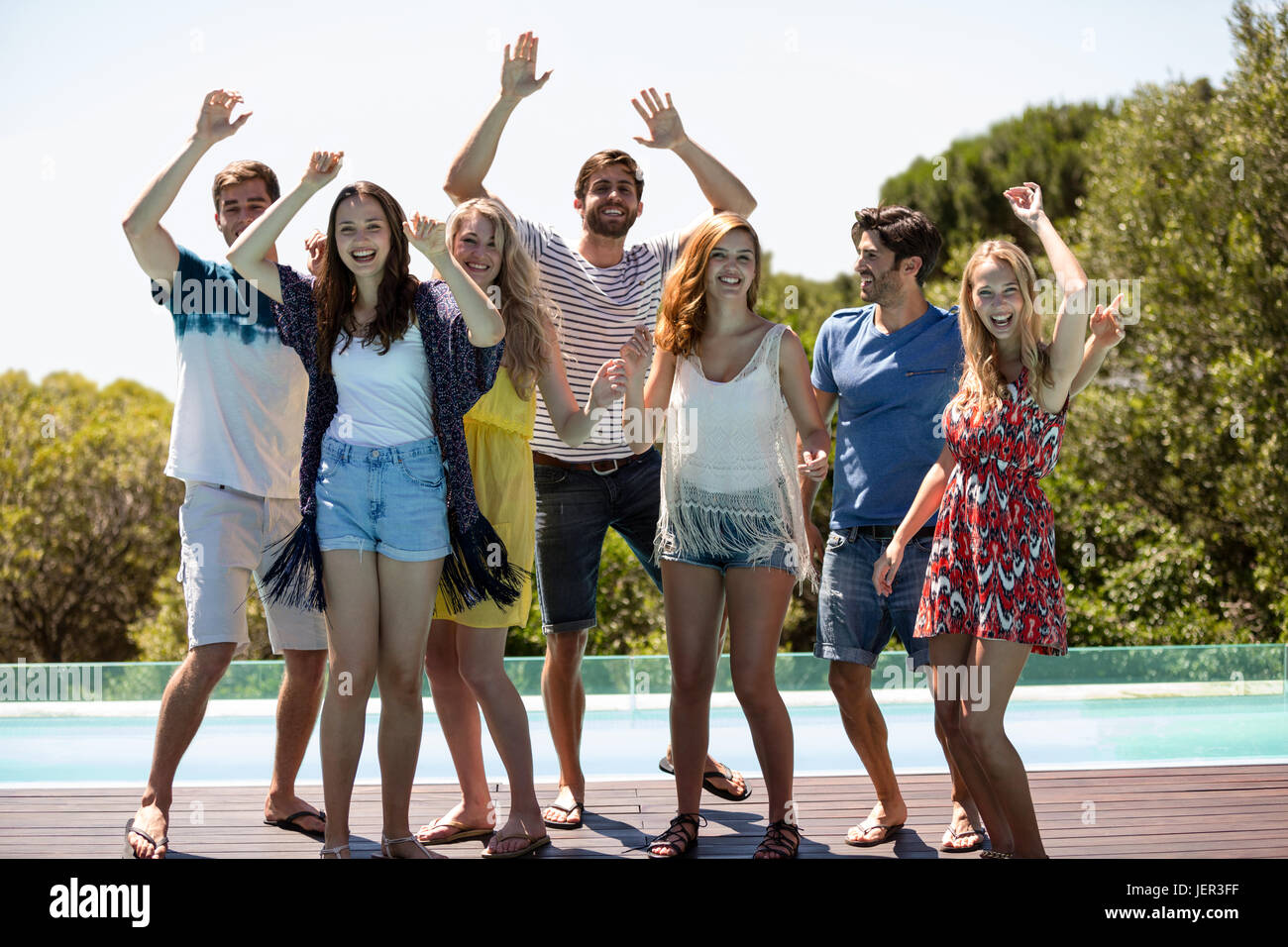 Happy friends dancing near the swimming pool Stock Photo - Alamy