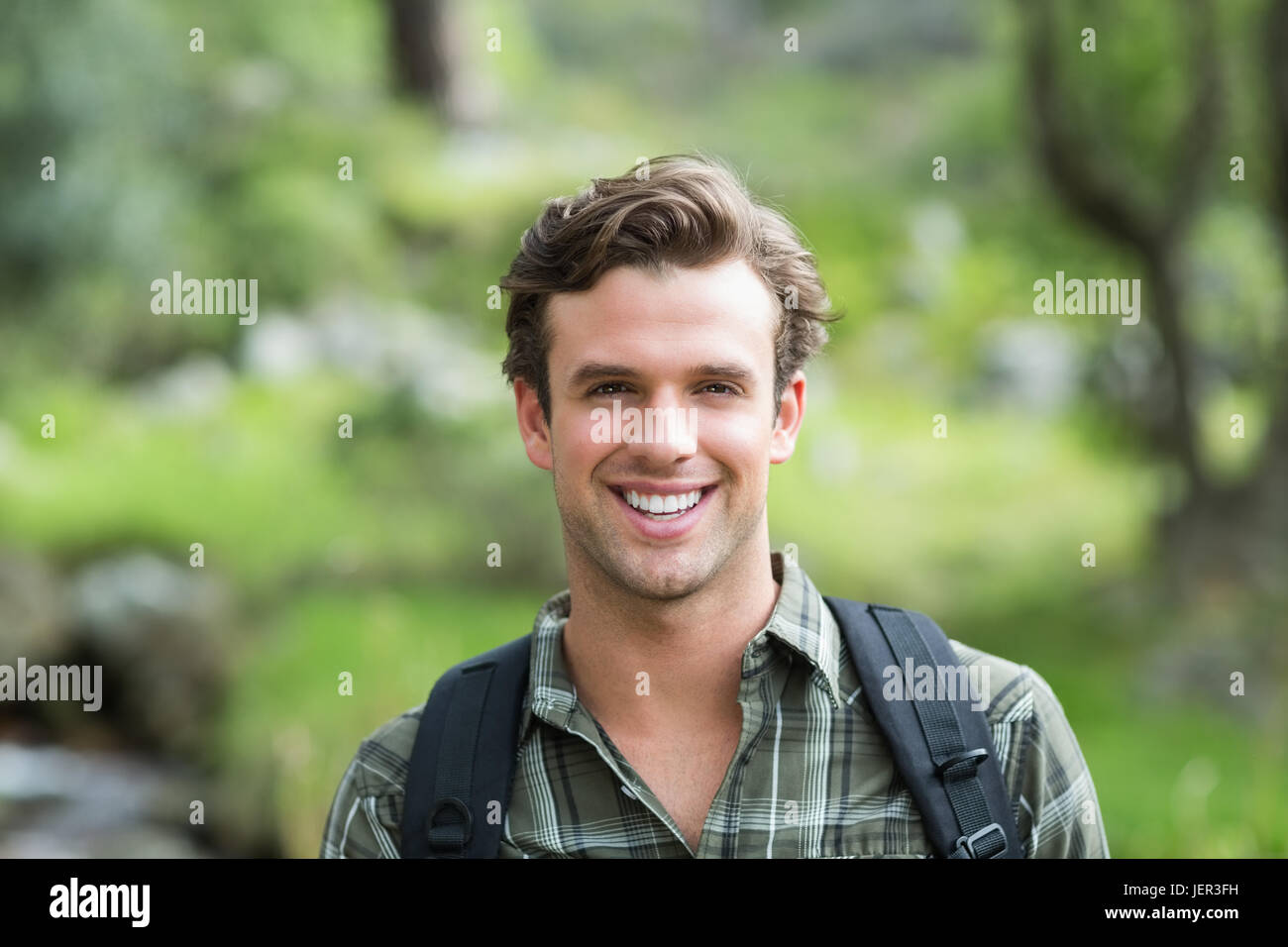 Handsome man smiling at the camera Stock Photo - Alamy