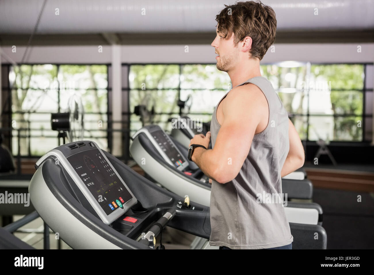 Man running on thread mill Stock Photo - Alamy