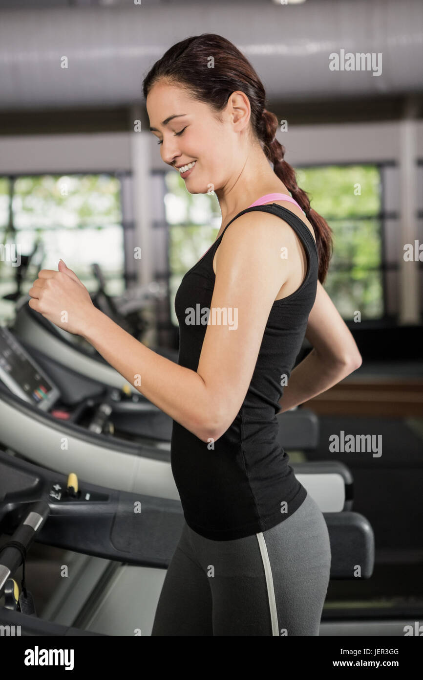 Happy woman jogging on treadmill Stock Photo - Alamy