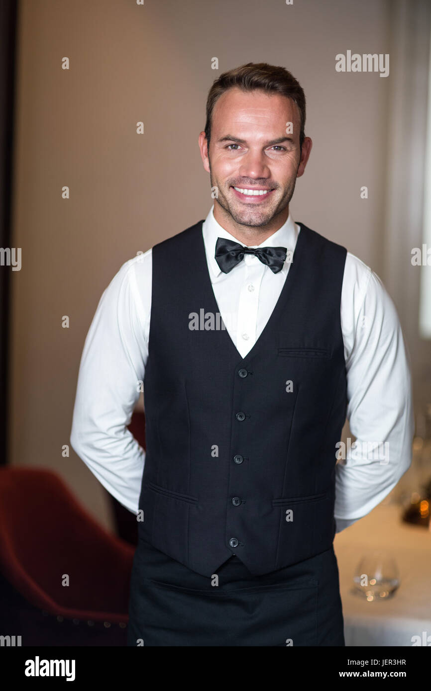 Portrait of smiling waiter Stock Photo - Alamy