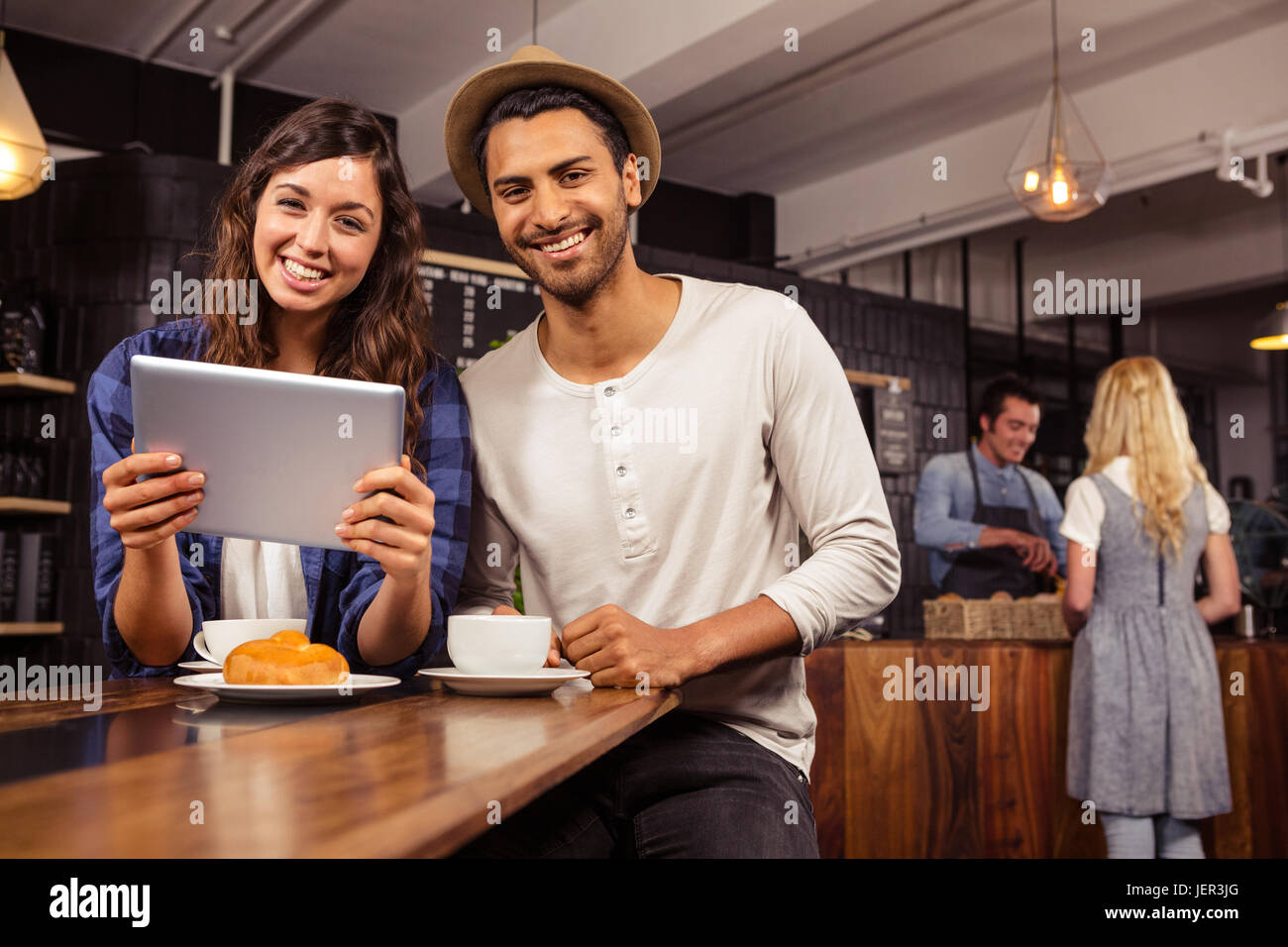 Couple using a tablet Stock Photo - Alamy