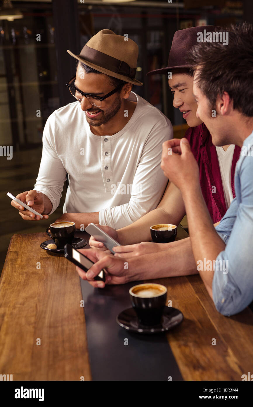 Friends using smartphones Stock Photo - Alamy