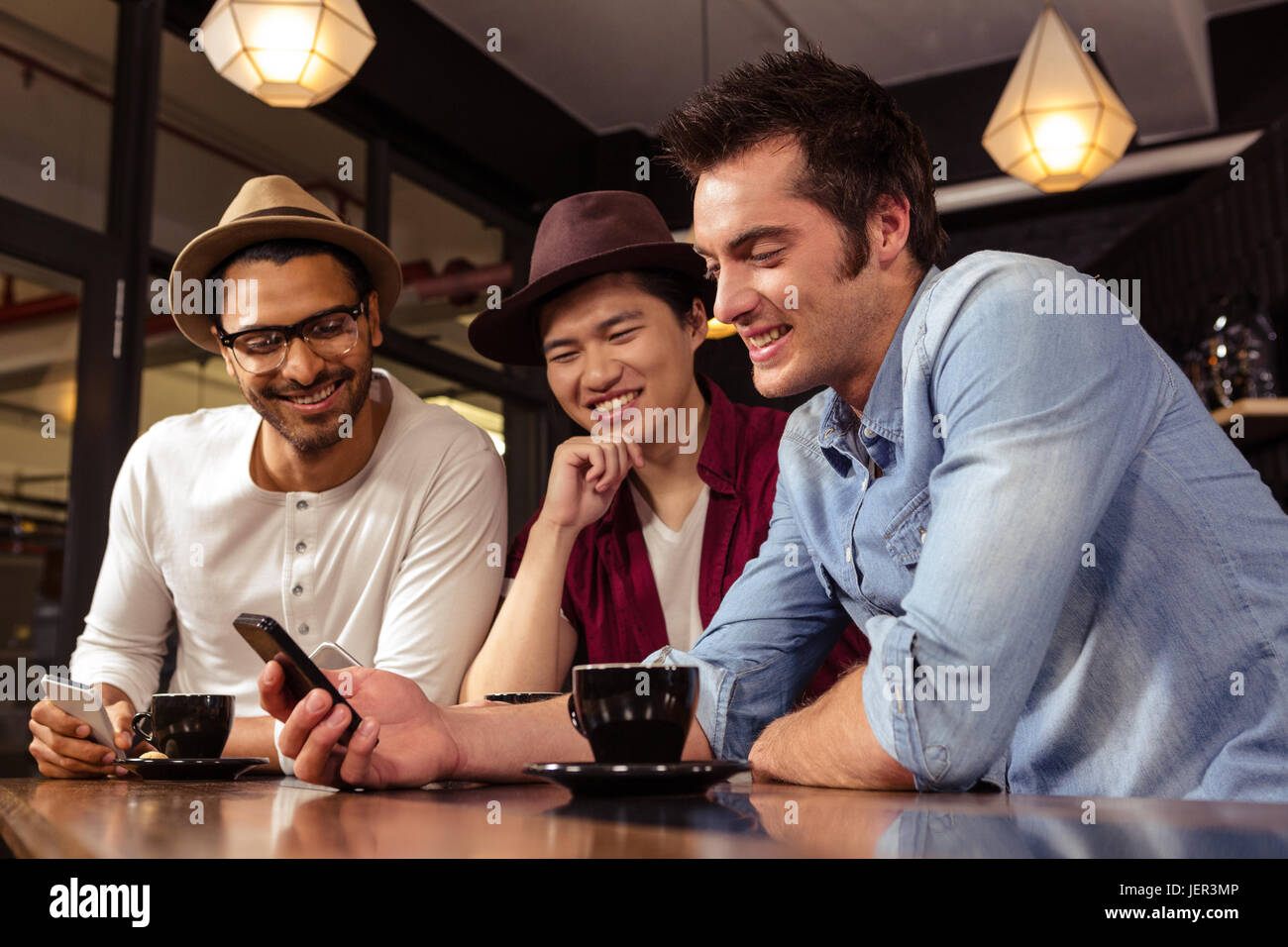 Friends using smartphones Stock Photo - Alamy