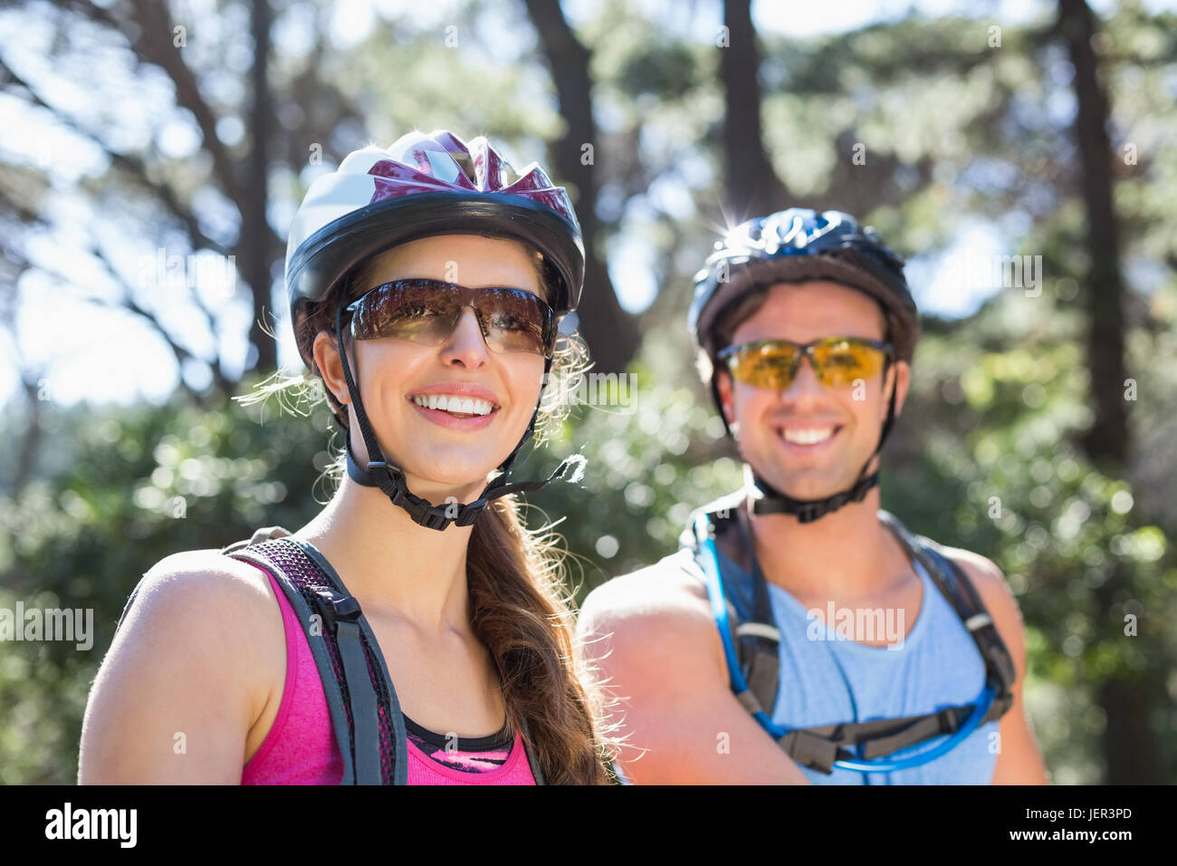 Portrait of smiling couple wearing helmets Stock Photo - Alamy