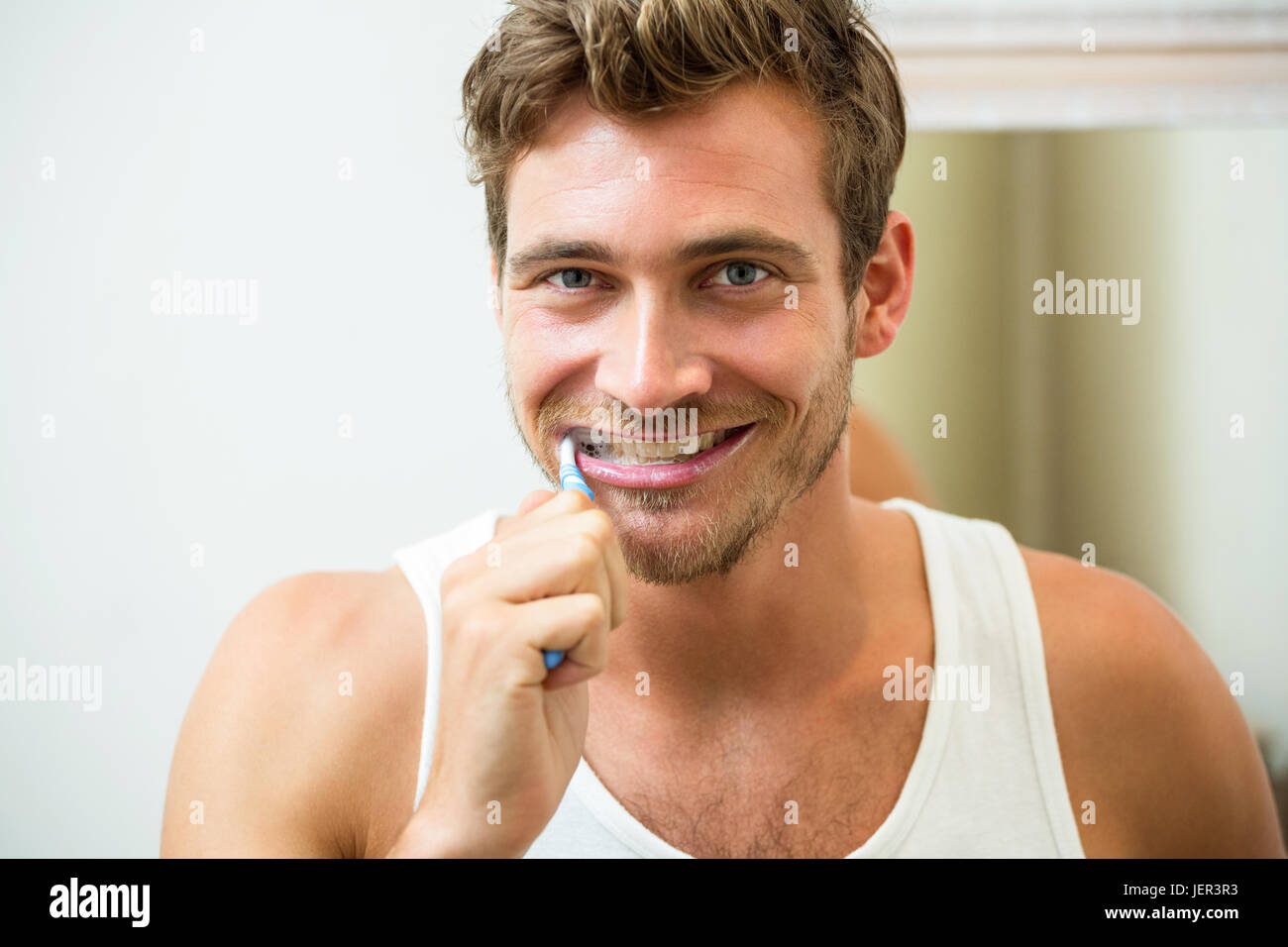 Young man brushing teeth Stock Photo - Alamy