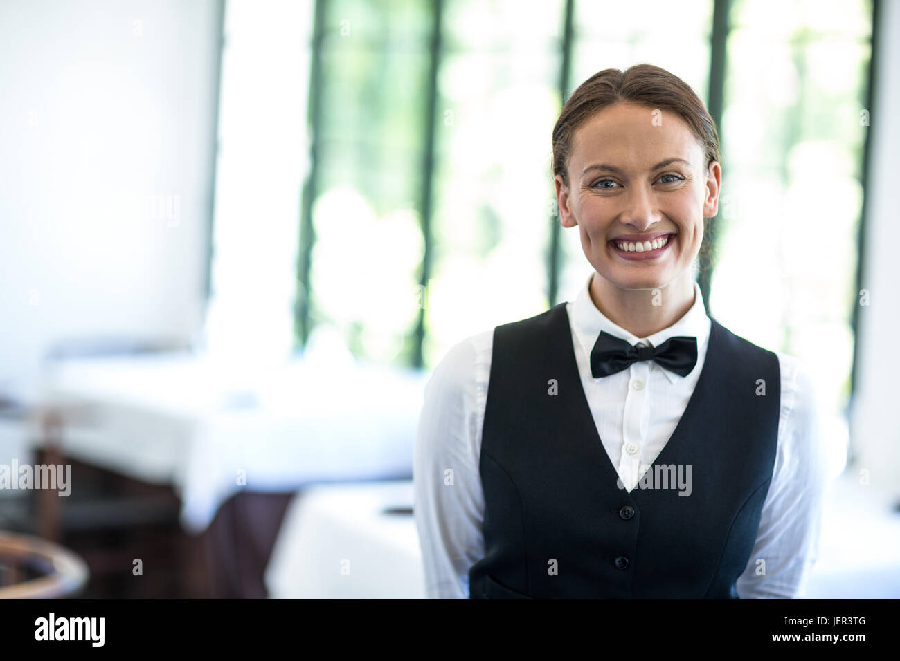 Happy waitress smiling at camera Stock Photo - Alamy