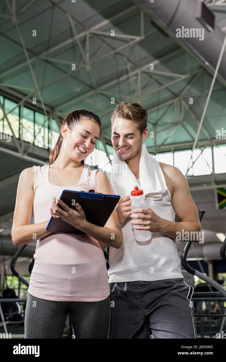Man talking to trainer after a workout Stock Photo - Alamy