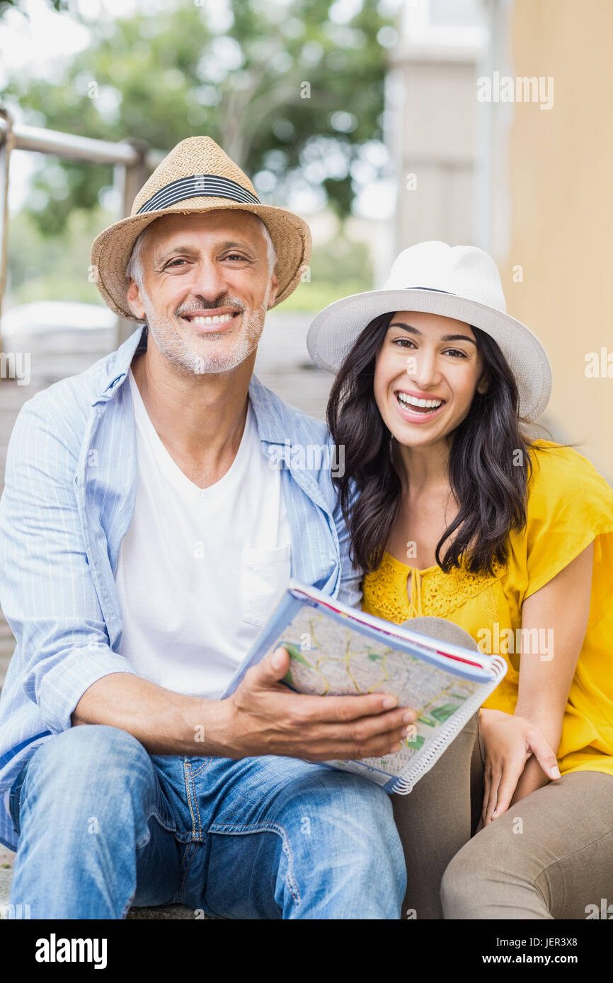 Portrait of happy couple with map Stock Photo - Alamy