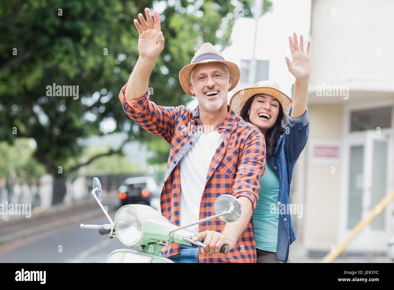 Smiling looking at camera sitting hand raised hi-res stock photography ...