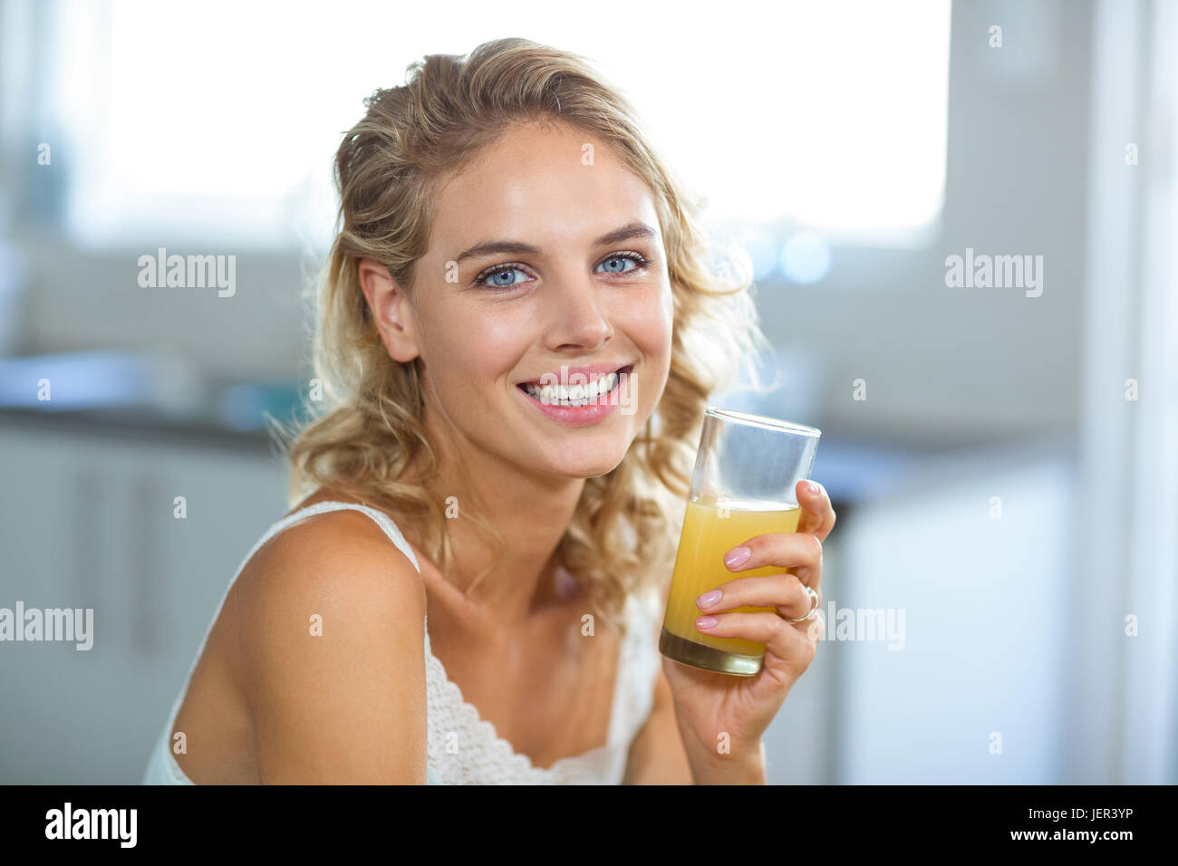 Woman holding juice glass hi-res stock photography and images - Alamy