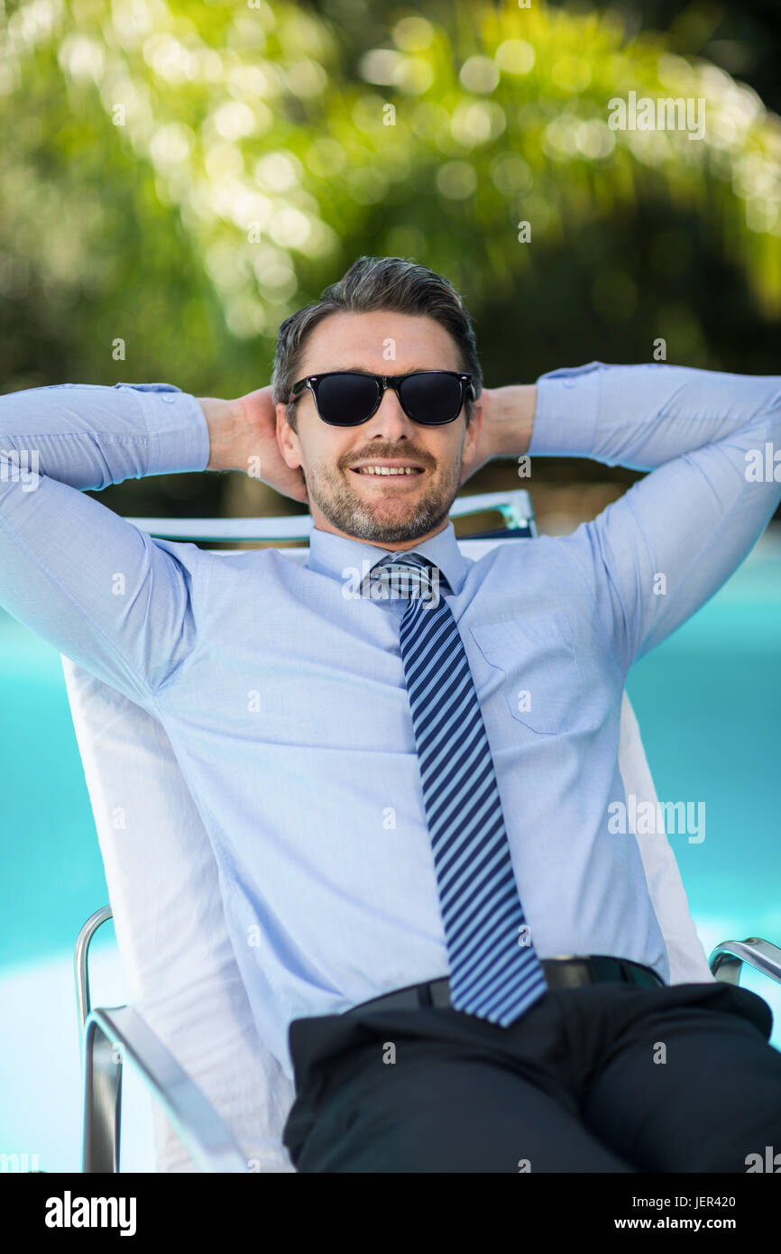 Smart man relaxing on sun lounger Stock Photo - Alamy
