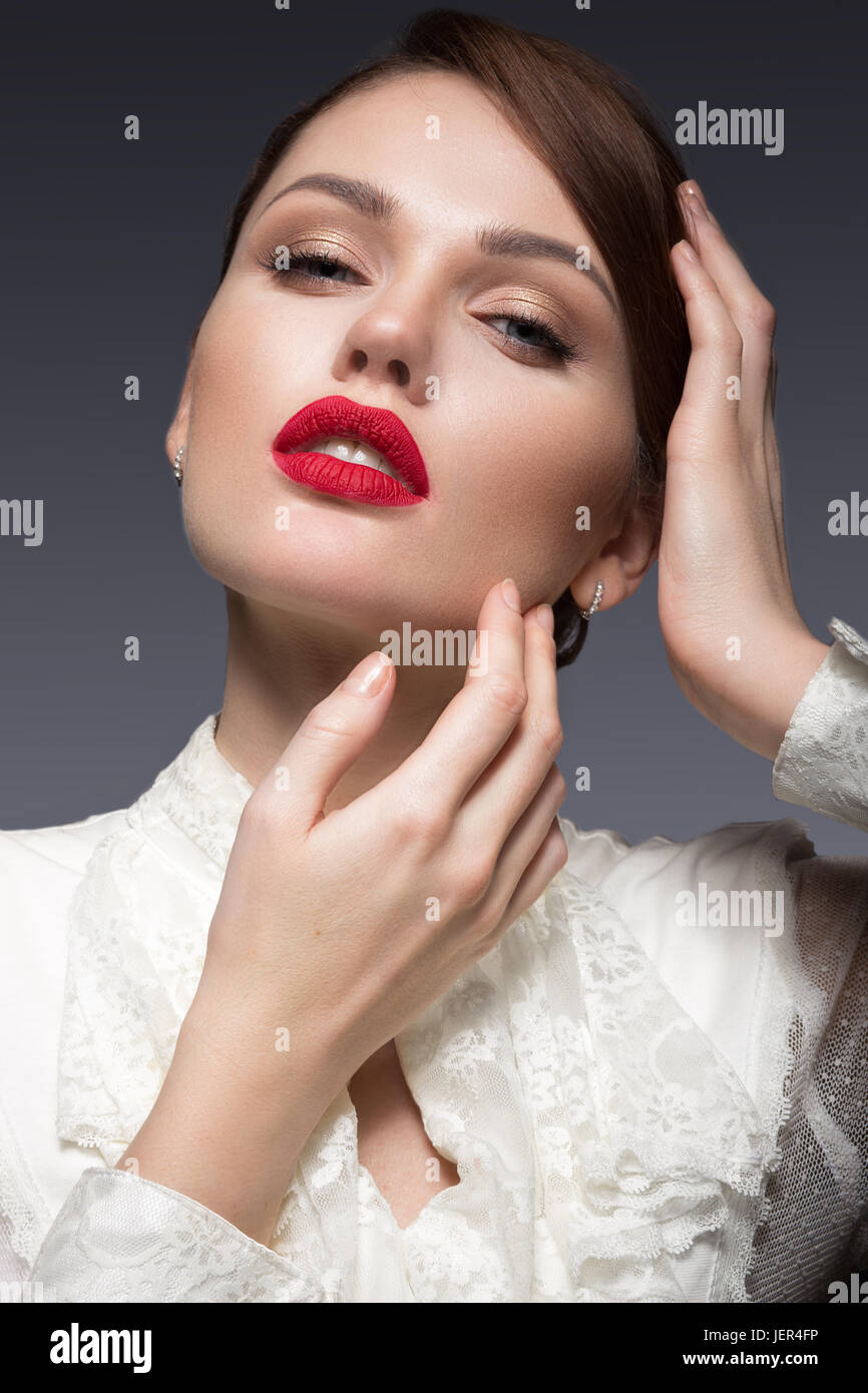 Beautiful girl with red lips in white clothes in the form of retro ...