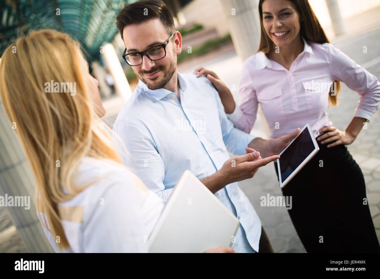 Picture of young attractive business partners standing outdoor Stock ...