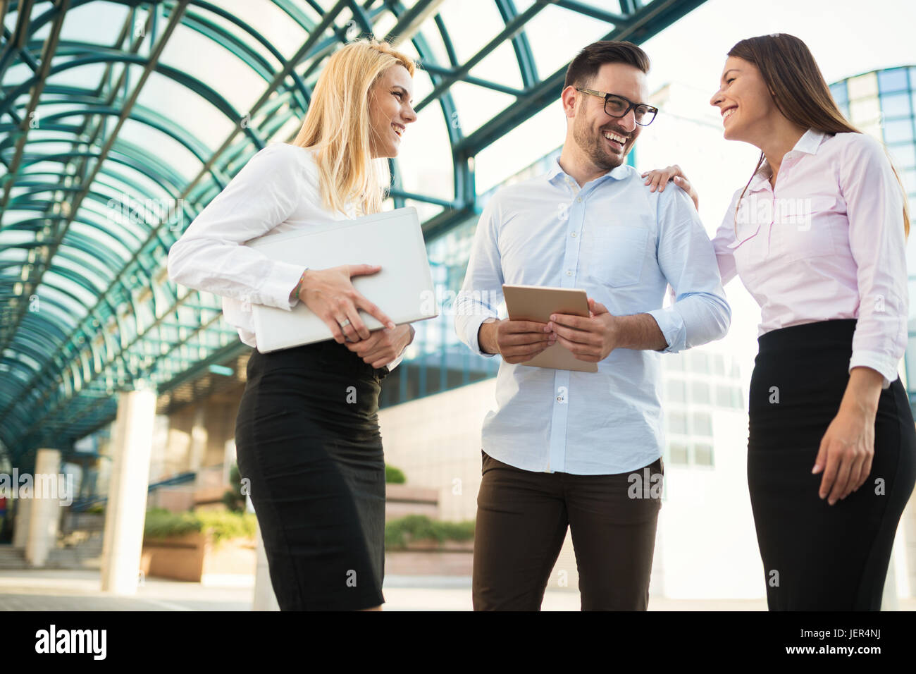 Picture of young attractive business partners standing outdoor Stock ...