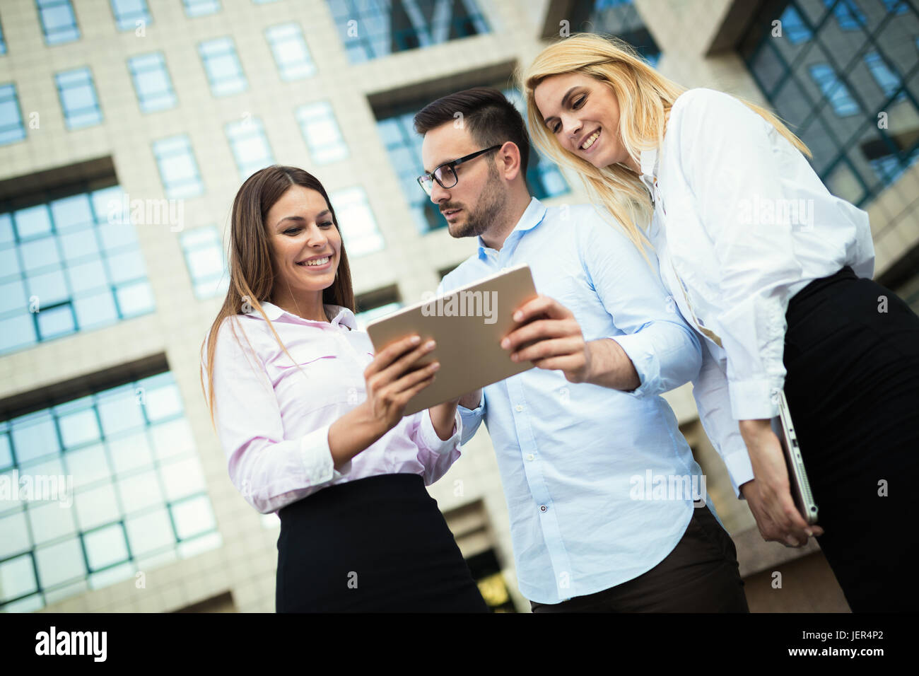 Picture of young attractive business partners standing outdoor Stock ...