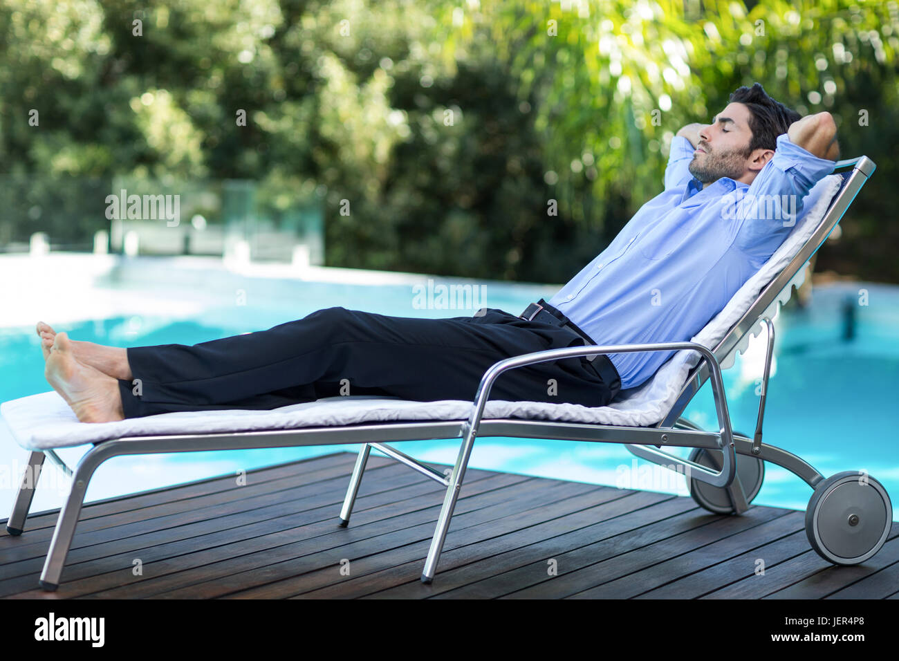 Smart man relaxing on sunlounger Stock Photo - Alamy