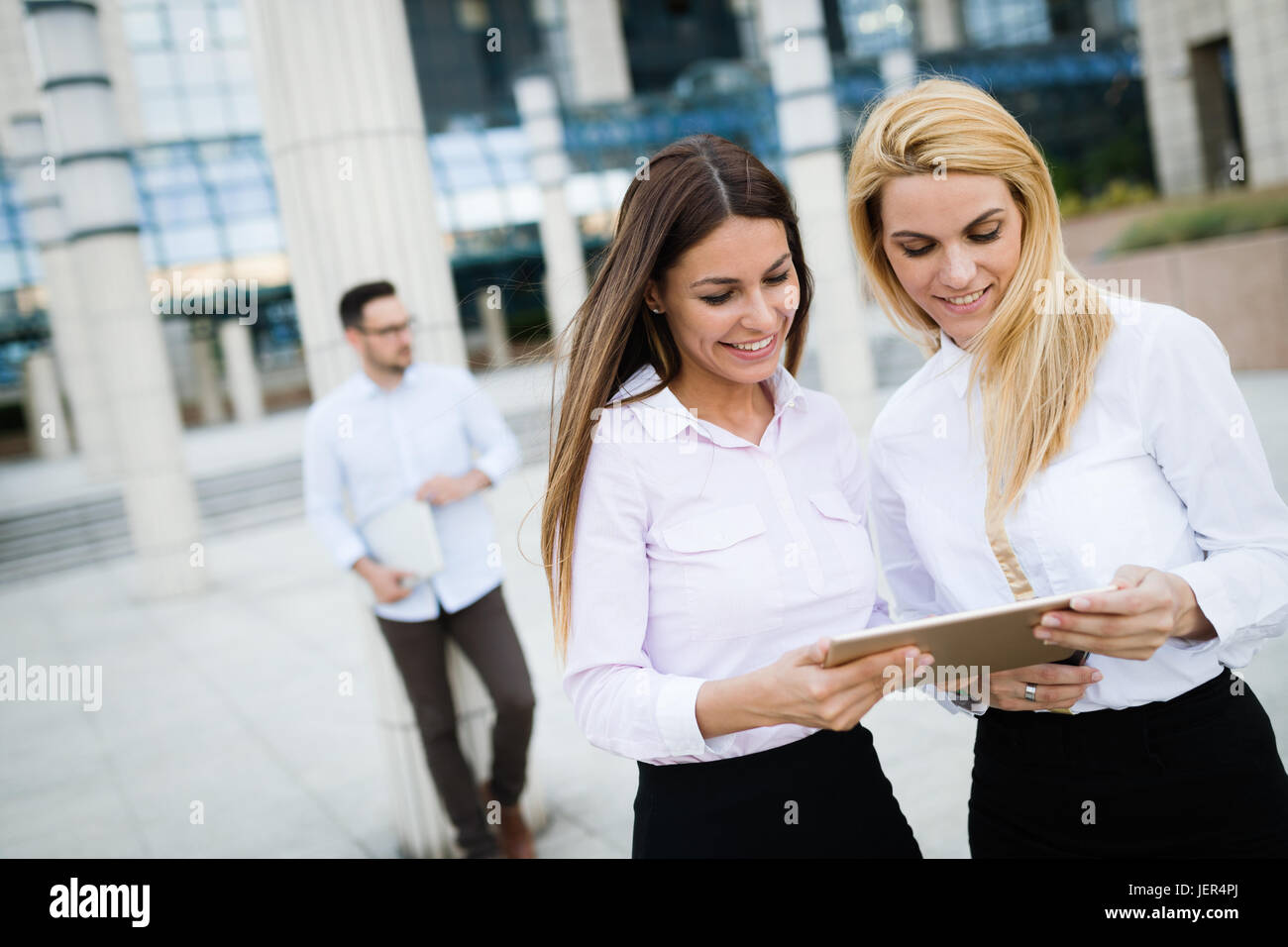 Picture of two young beautiful women as business partners standing ...
