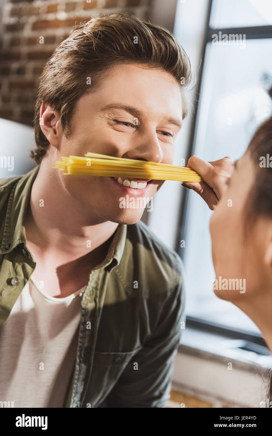 young people having fun together, man with pasta as mustache Stock ...