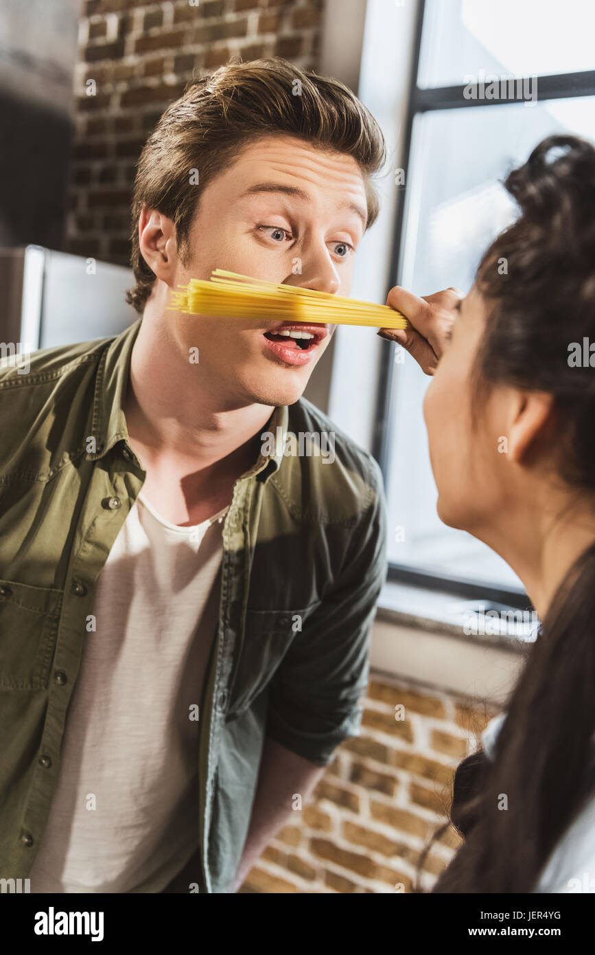 young people having fun together, man with pasta as mustache Stock ...