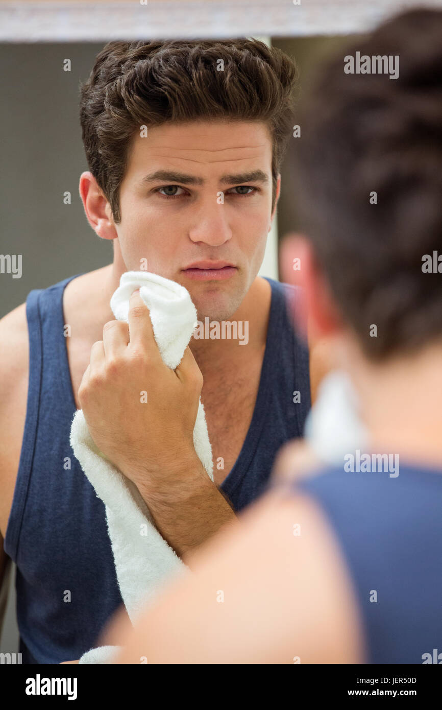 Man wiping his face with napkin Stock Photo - Alamy