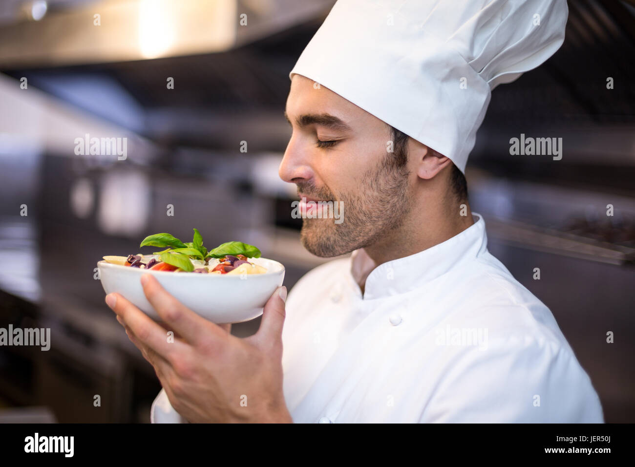 Handsome chef smelling pasta Stock Photo - Alamy