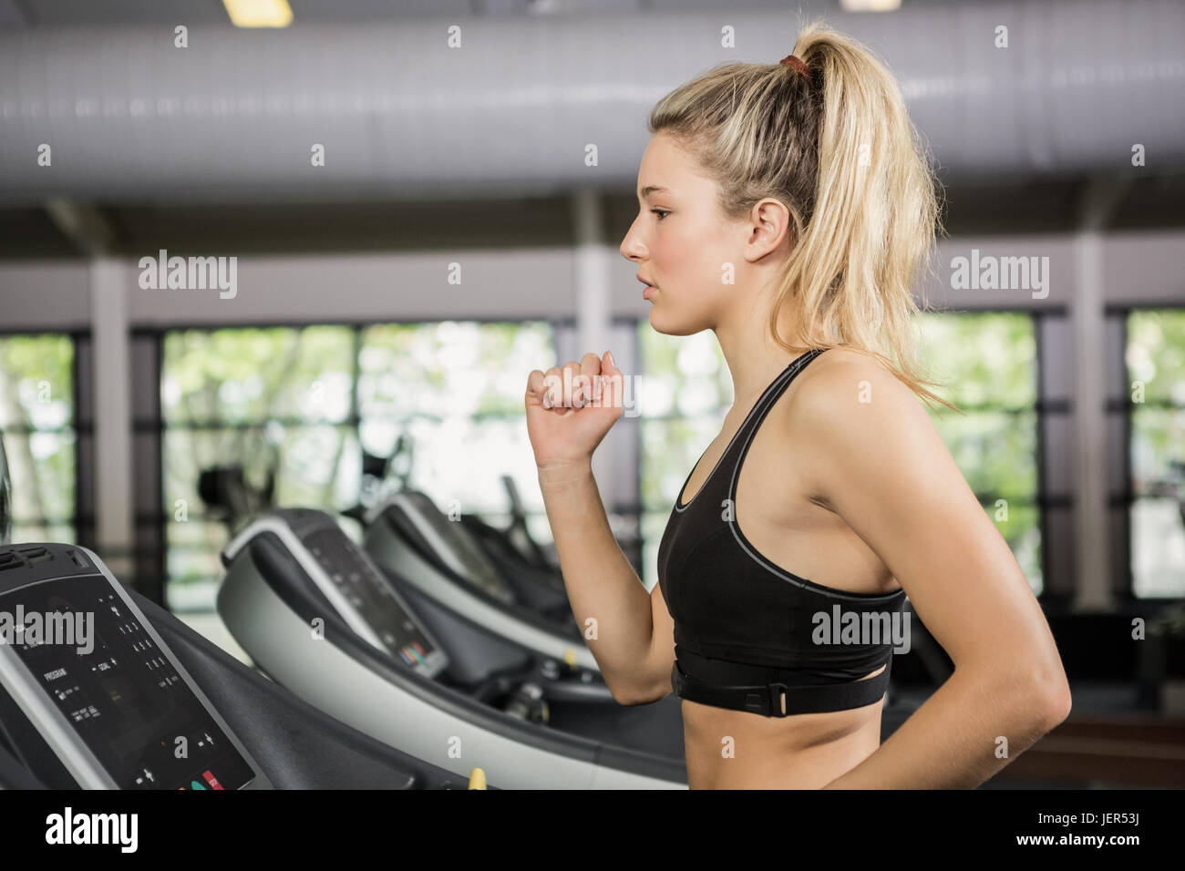 Woman walking on treadmill Stock Photo - Alamy