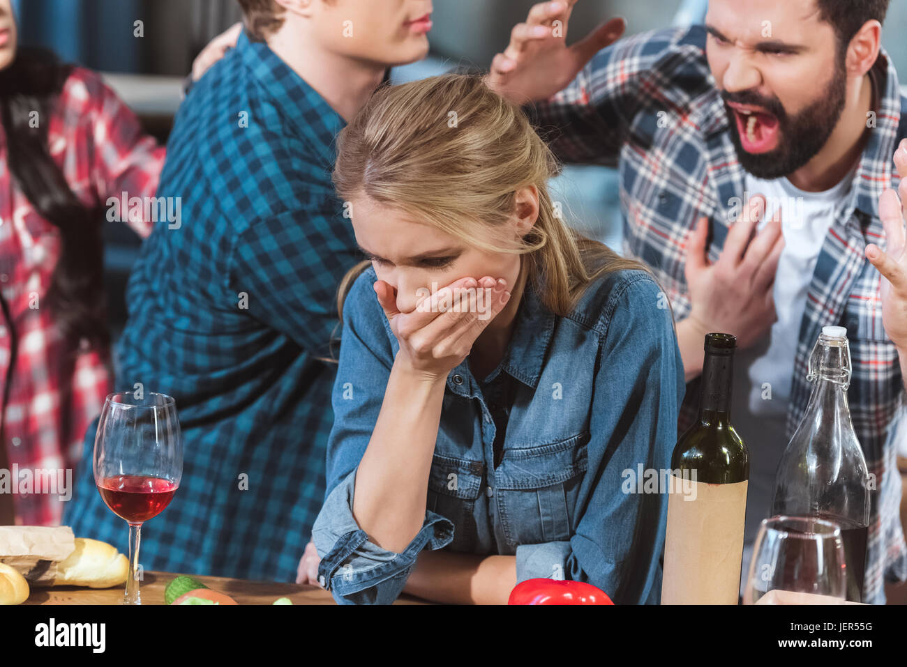 Young couple quarrel, man calming another that yelling to his ...