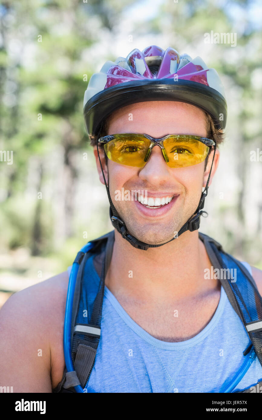 Portrait of smiling young man wearing helmet Stock Photo - Alamy