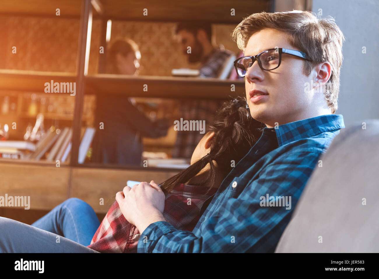 Young loving couple resting on couch Stock Photo - Alamy
