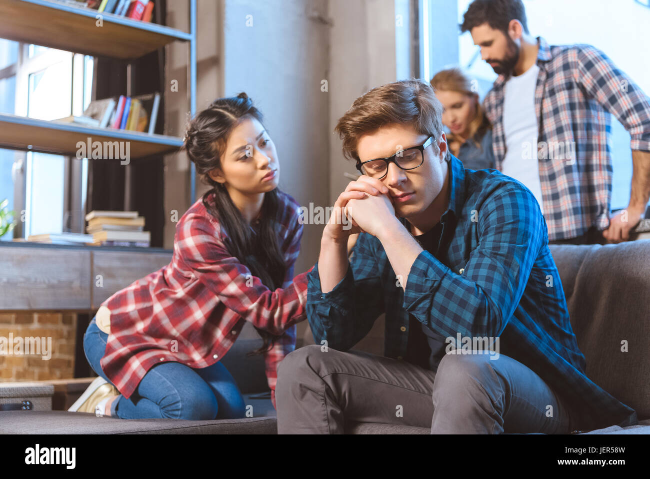 Young asian woman supporting male friend in depression, other people on ...