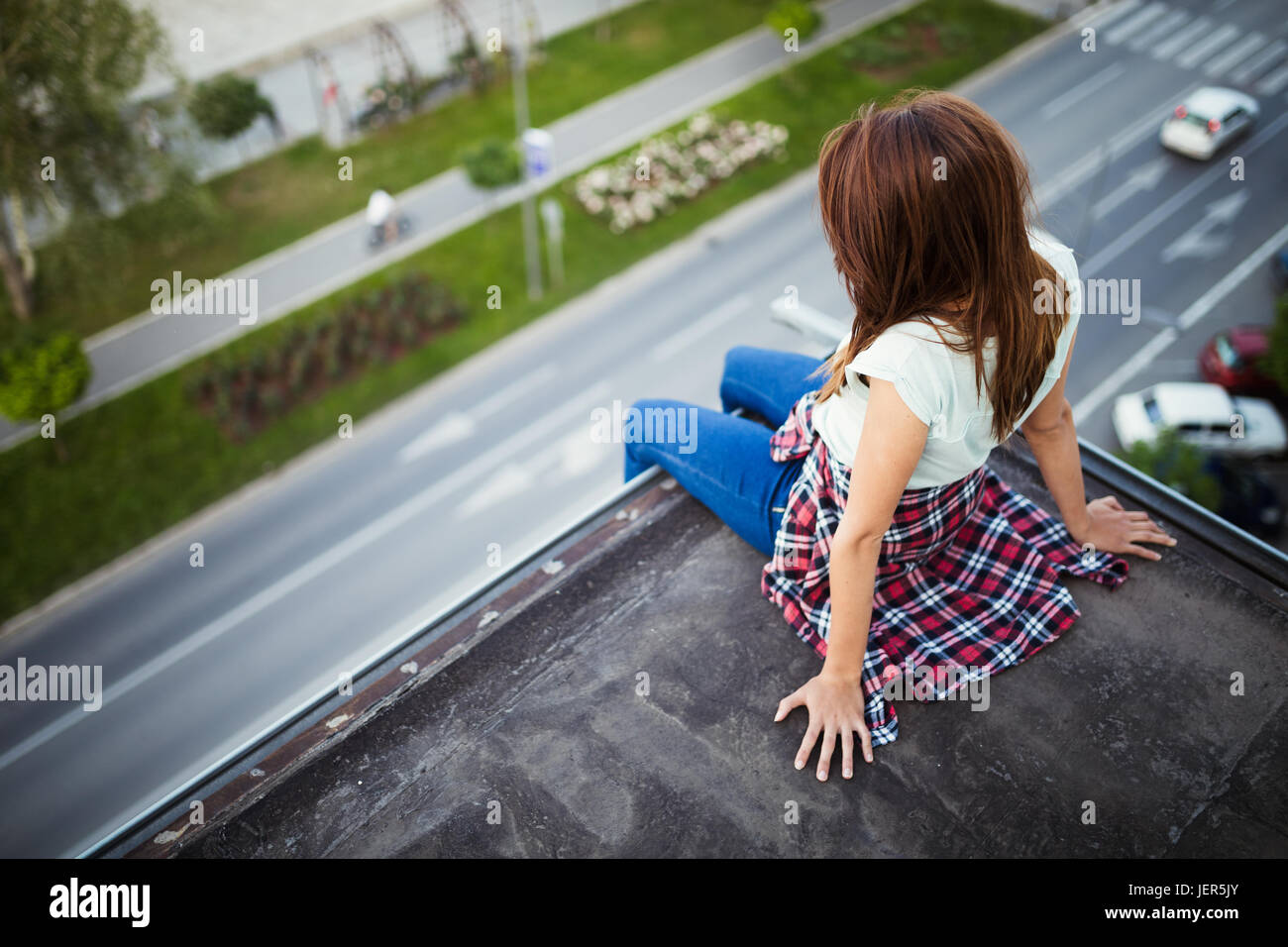Girl sitting roof hi-res stock photography and images - Alamy