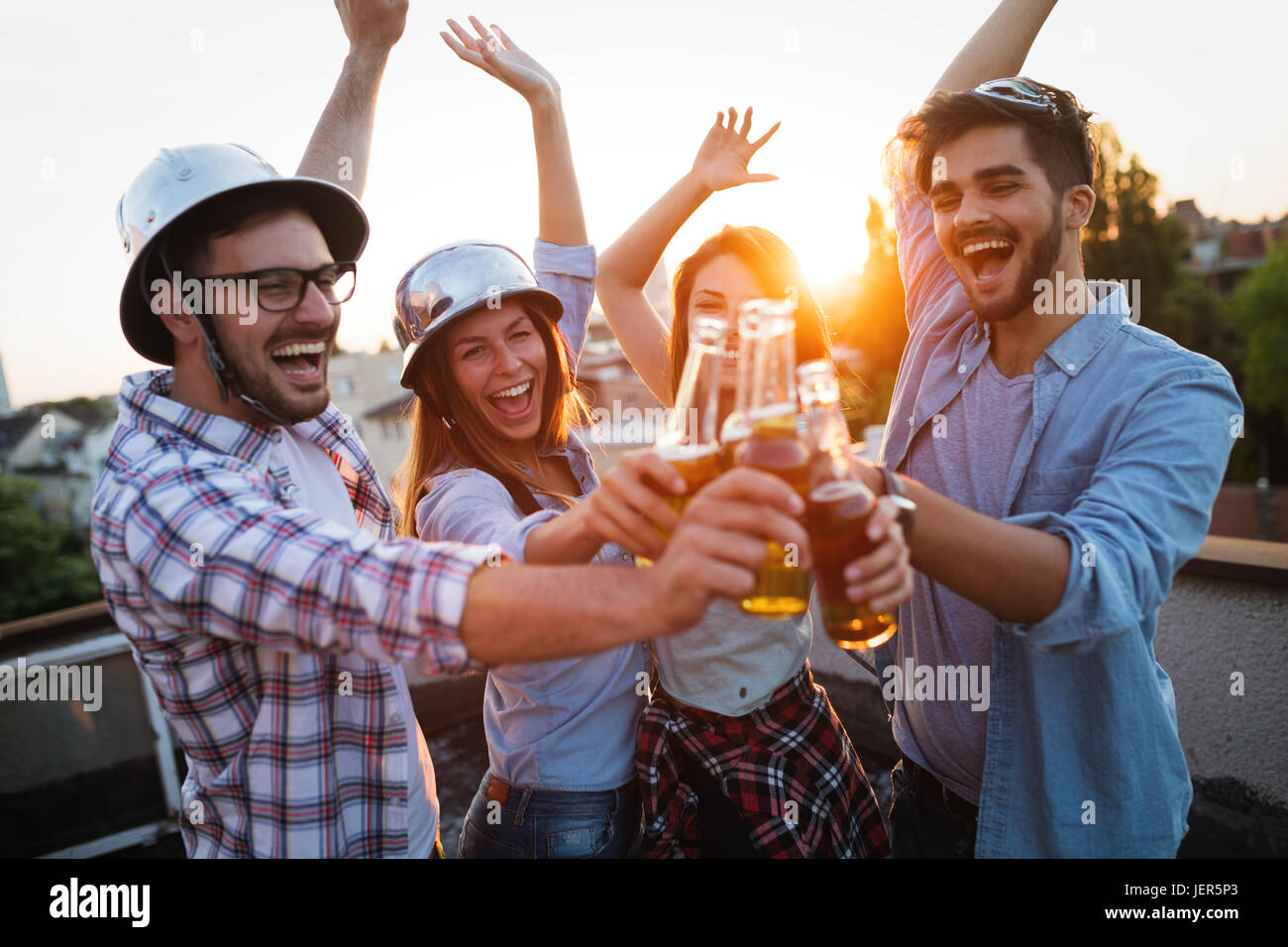 Happy cheerful friends spending fun times together and drinking Stock ...