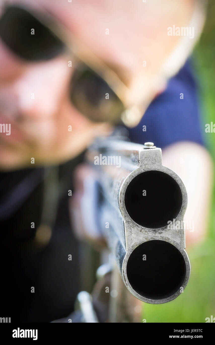 Man takes aim with a hunting rifle closeup Stock Photo - Alamy
