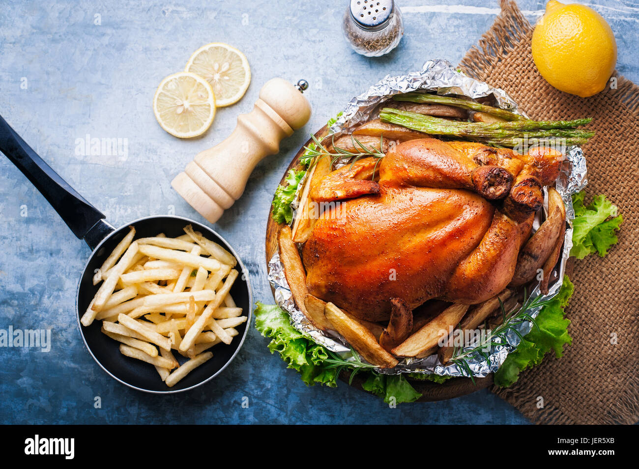 Whole roasted chicken with vegetables on wood table Stock Photo - Alamy