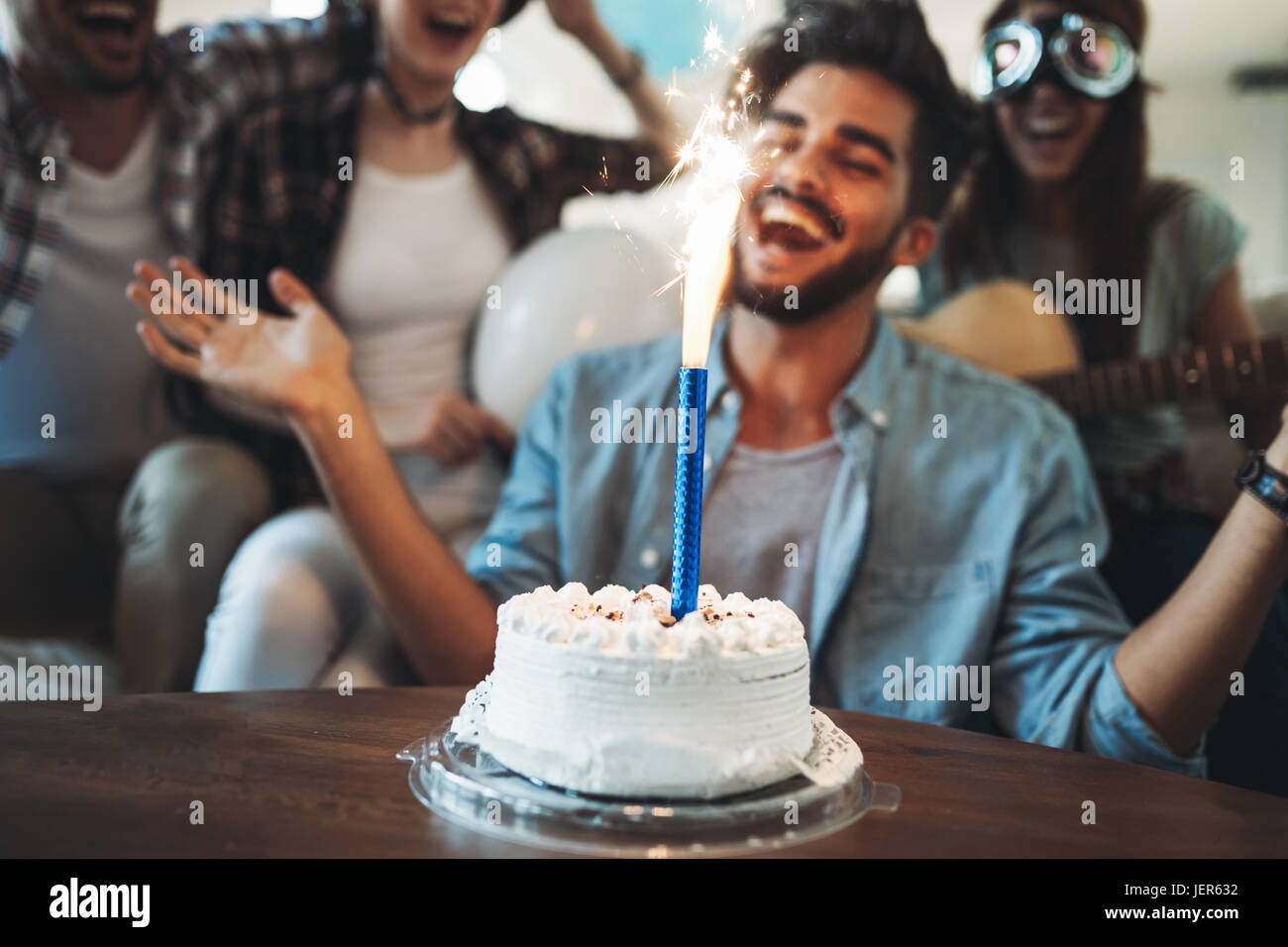 Cheerful young man having lot of fun on party Stock Photo - Alamy