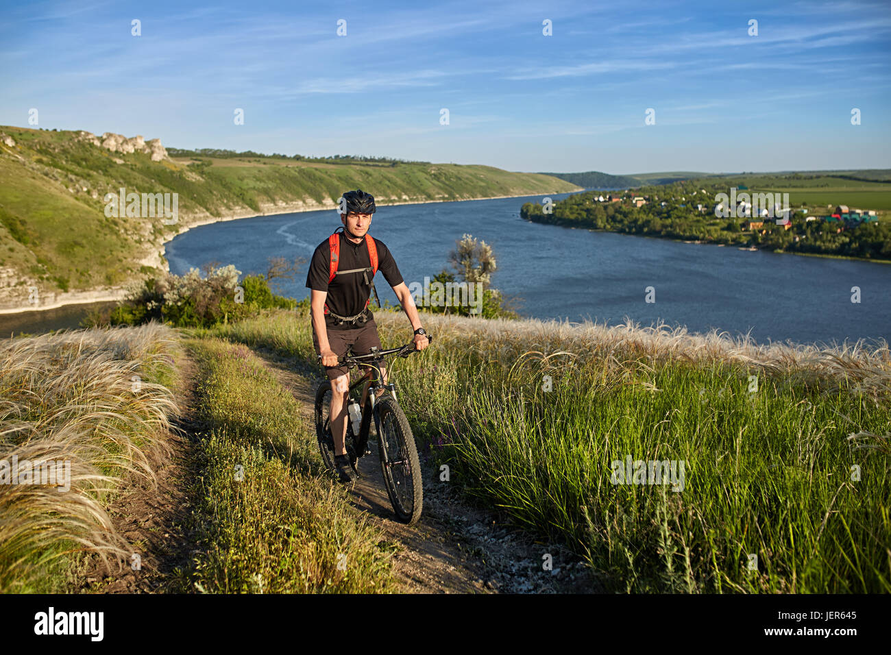 Man riding mountain bike uphill hi-res stock photography and images - Alamy